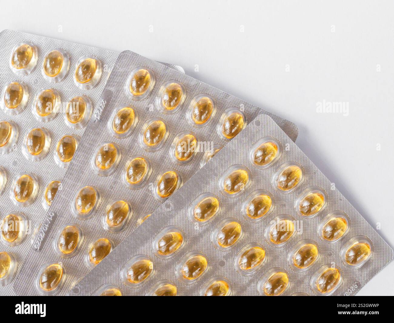 Close-Up of Fish Oil Capsules in Blister Packs on White Surface. health ...