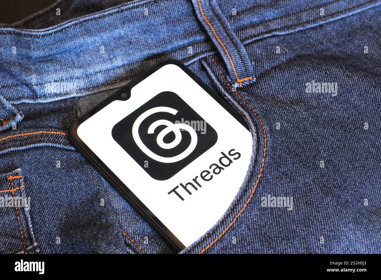 In this photo illustration, the Threads logo is seen displayed on a ...