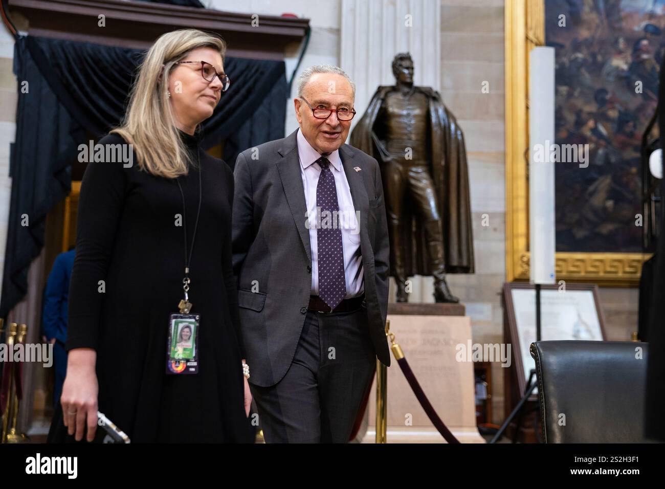 Senate Minority Leader Chuck Schumer (D-N.Y.) speaks with an aide ...