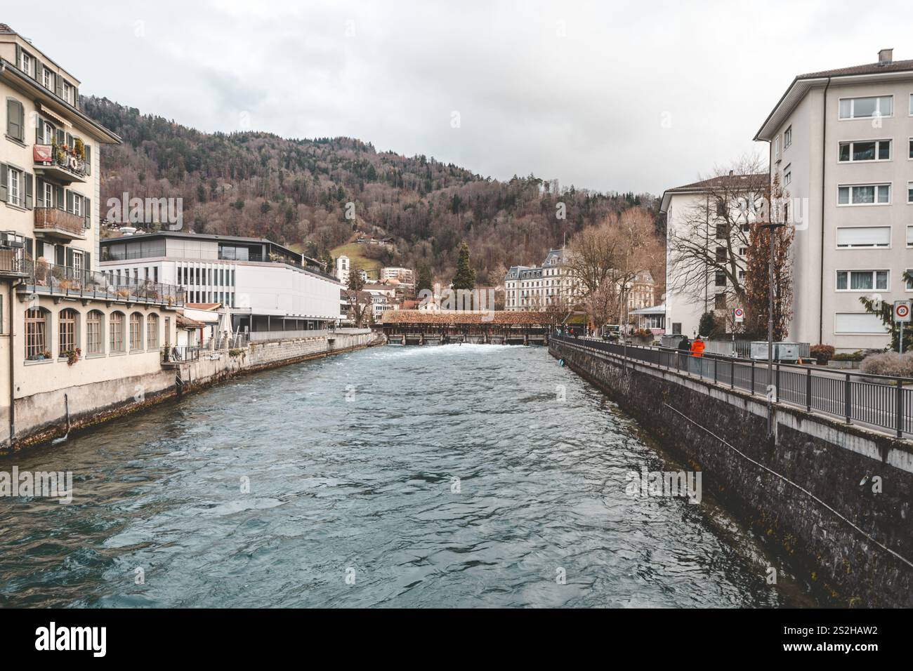 View of the Aare River and old covered bridge, in Thun, Switzerland in ...
