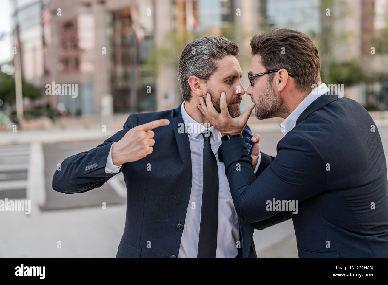 Two businessmen conflicting at fight outdoor. Businessmen having ...