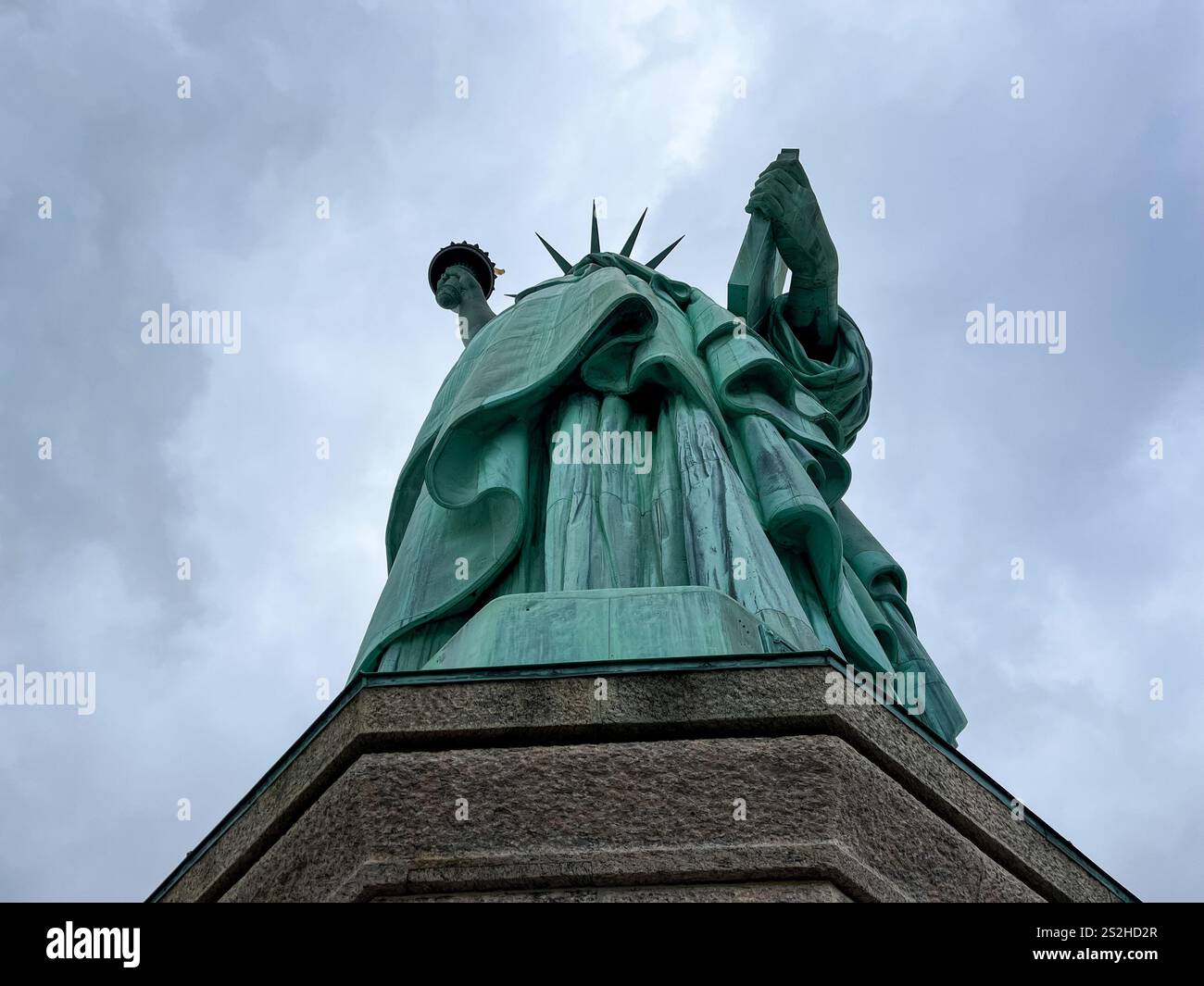 Majestic view of the Statue of Liberty from below, against a clear sky ...