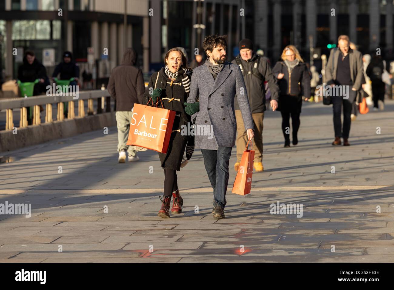 Winter tourists enjoy the late afternoon winter sunshine on London ...
