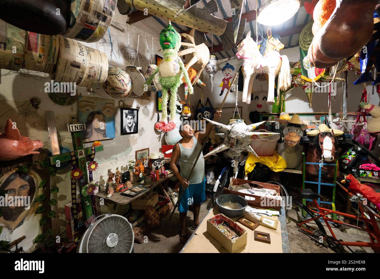 Baca, Mexico. 20th Nov, 2024. A man hanging up a pinata in his workshop ...