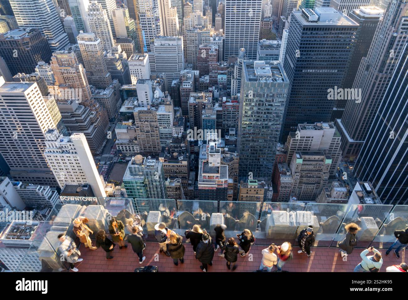 Top of the Rock observation platform with people illuminated at sunset ...