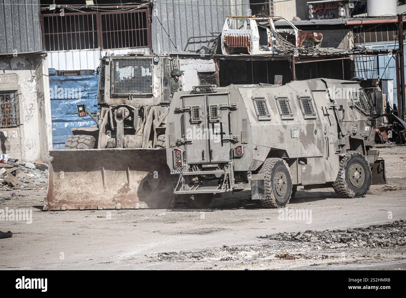 An Israeli military vehicles surround the Fara'a refugee camp near ...