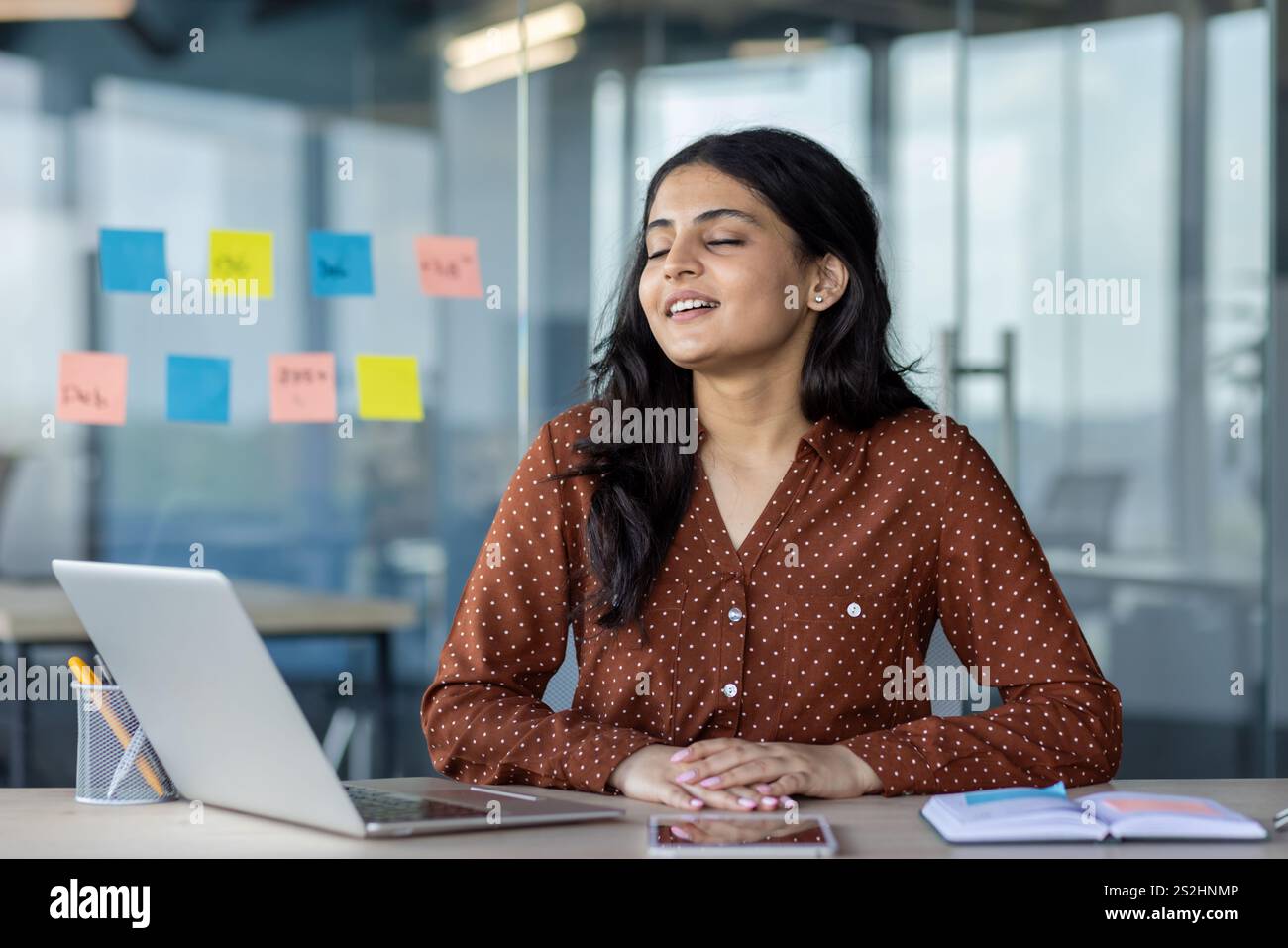 Successful woman relaxing and meditating with closed eyes, breathing ...