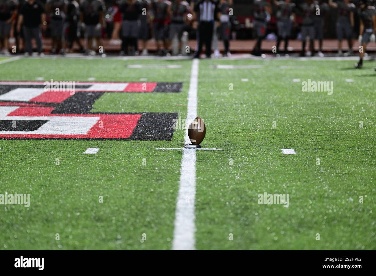 Football on a tee ready for kickoff Stock Photo - Alamy