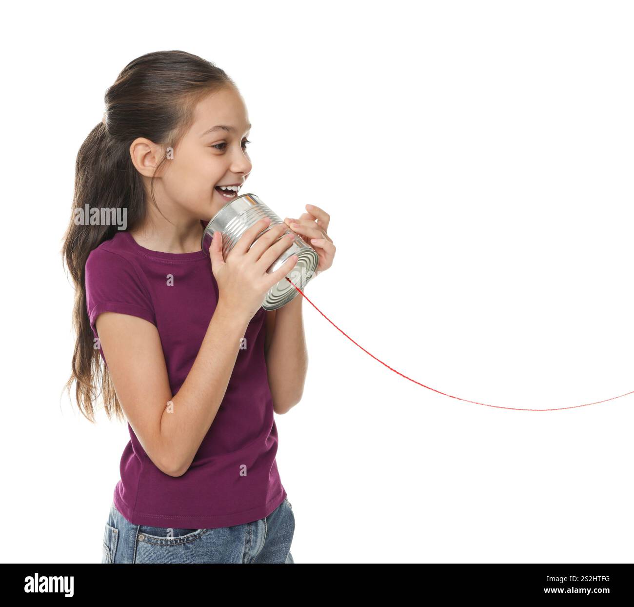 Girl using tin can telephone on white background Stock Photo - Alamy
