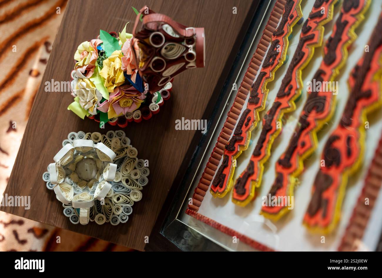 Designs crafted from quilling paper seen at a home-based workplace ...