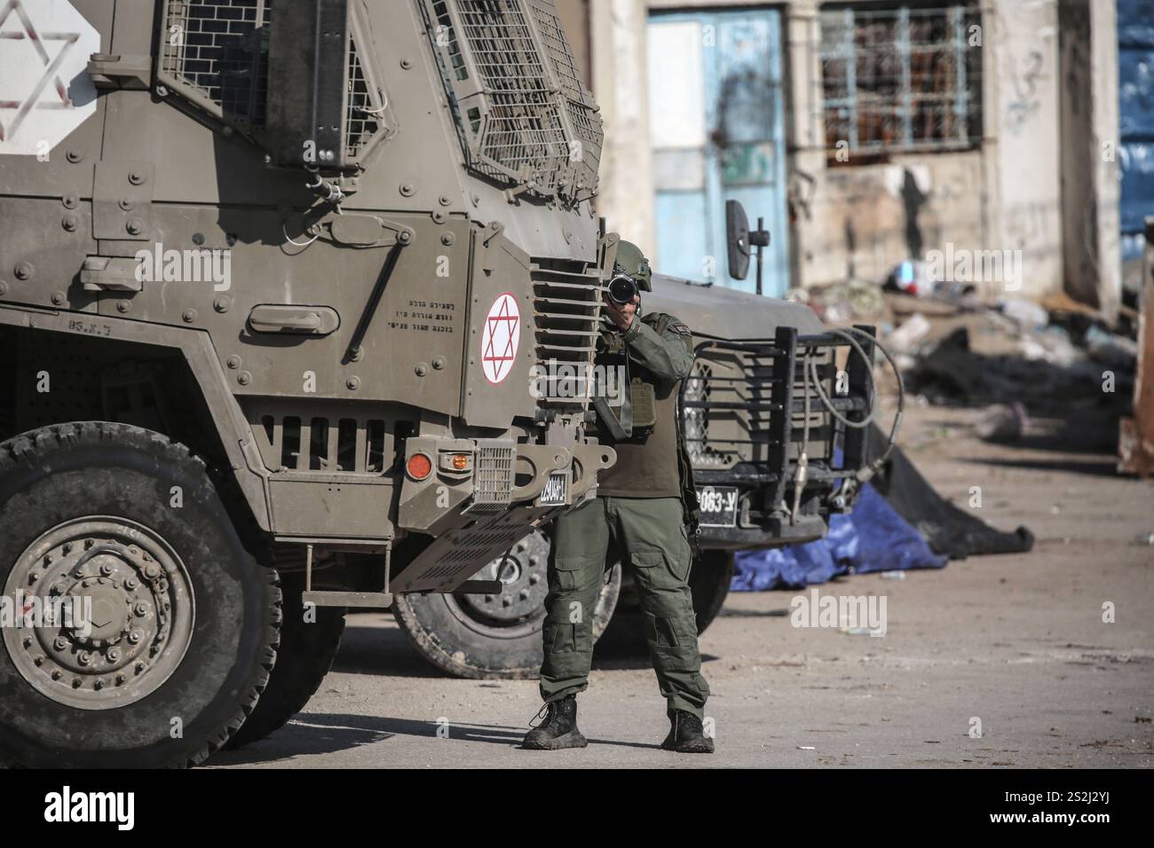 Jenin, Palestine. 07th Jan, 2025. An Israeli soldier takes position ...