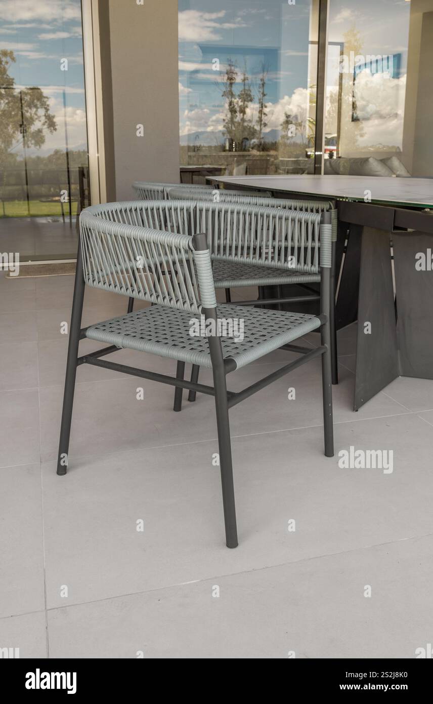 A stylish metal and wicker chair, combining modern and natural elements ...