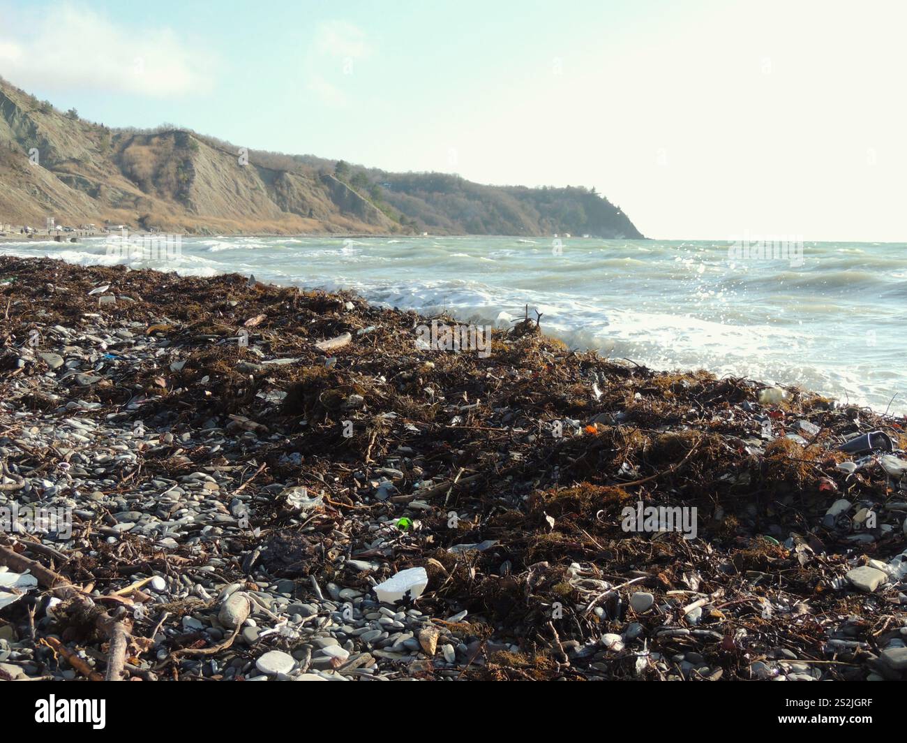 plastic garbage and household waste of tourists on the rocky coast of ...