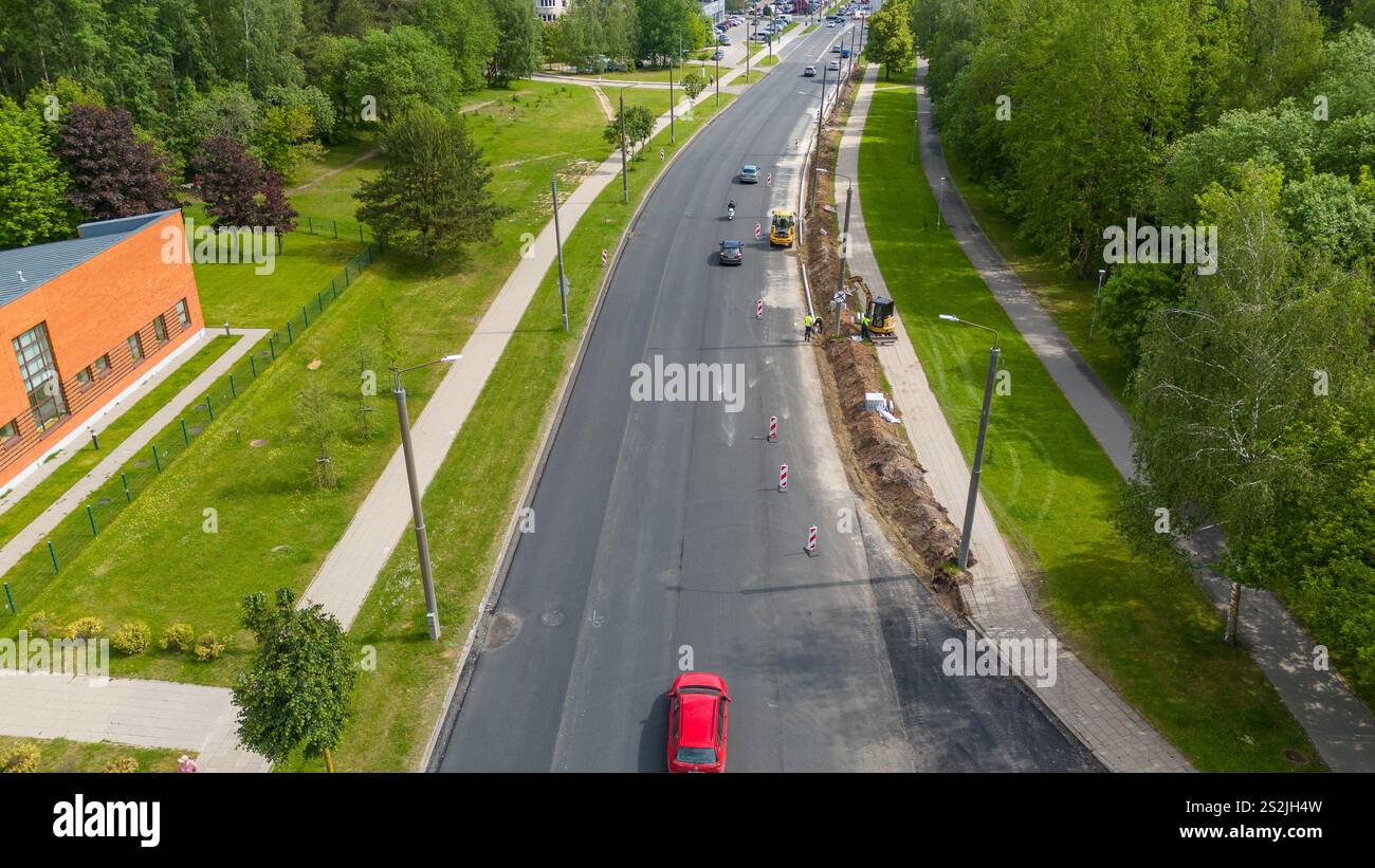 An aerial view of a road under construction, featuring vehicles on the ...