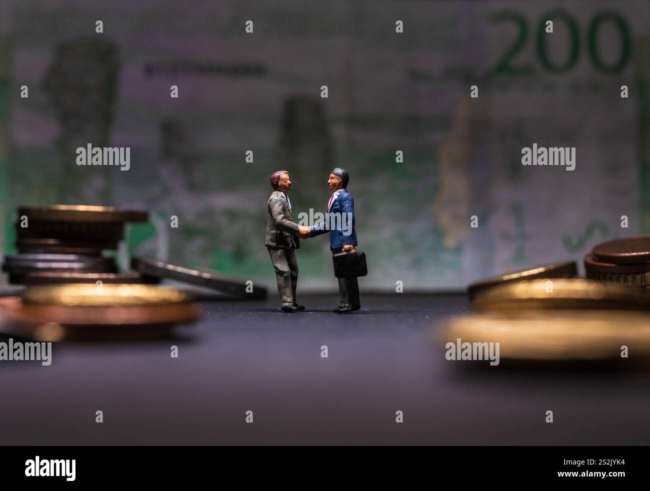 Two men shaking hands in front of a large bank note Stock Photo - Alamy