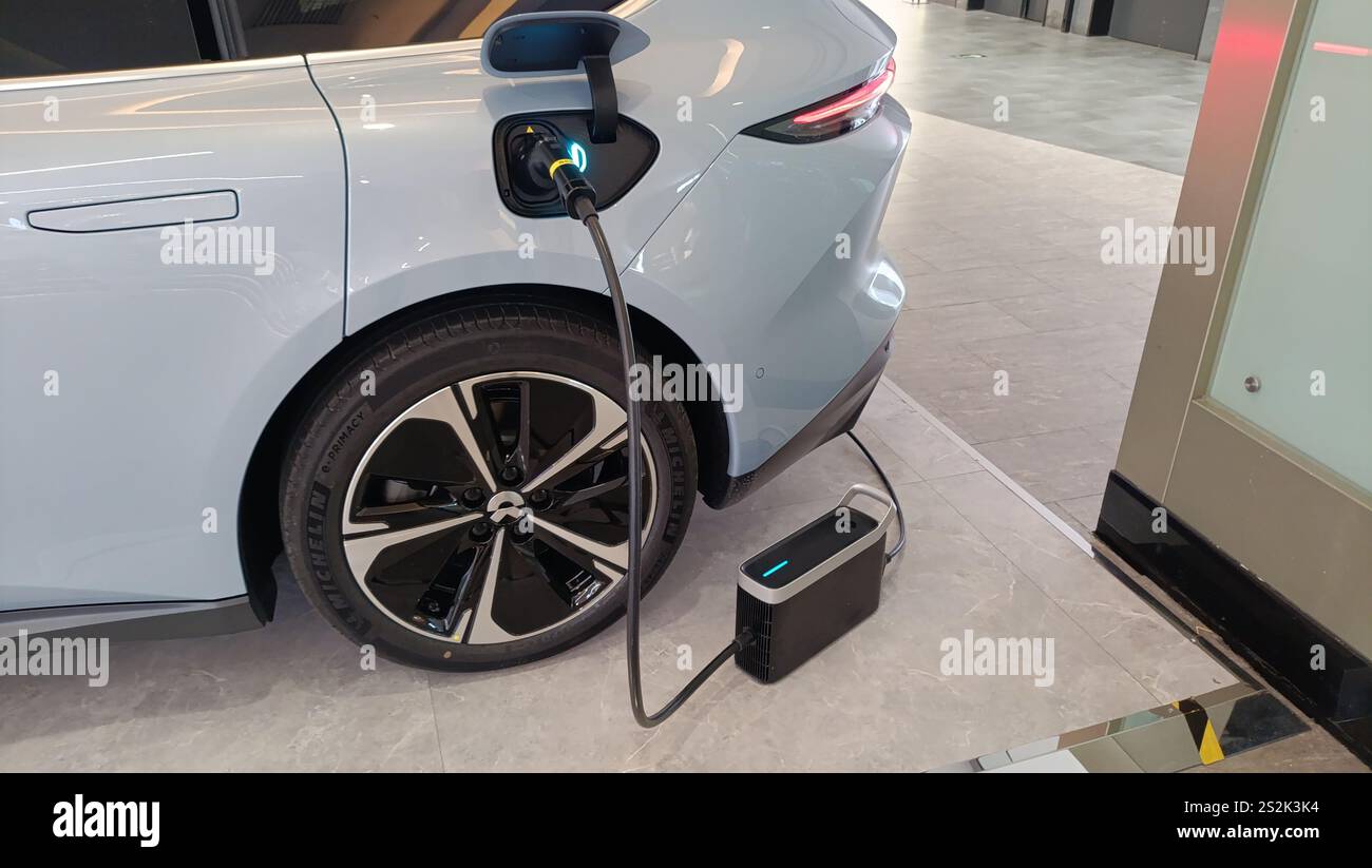 Canton, China -16th October 2024: Nio car in salon. Charger connected ...