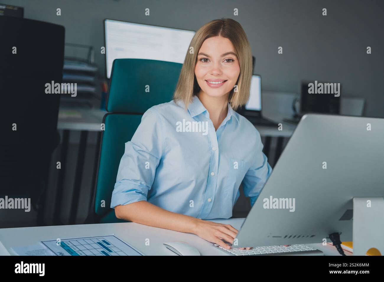 Photo of attractive young corporate woman use computer wear blue shirt ...