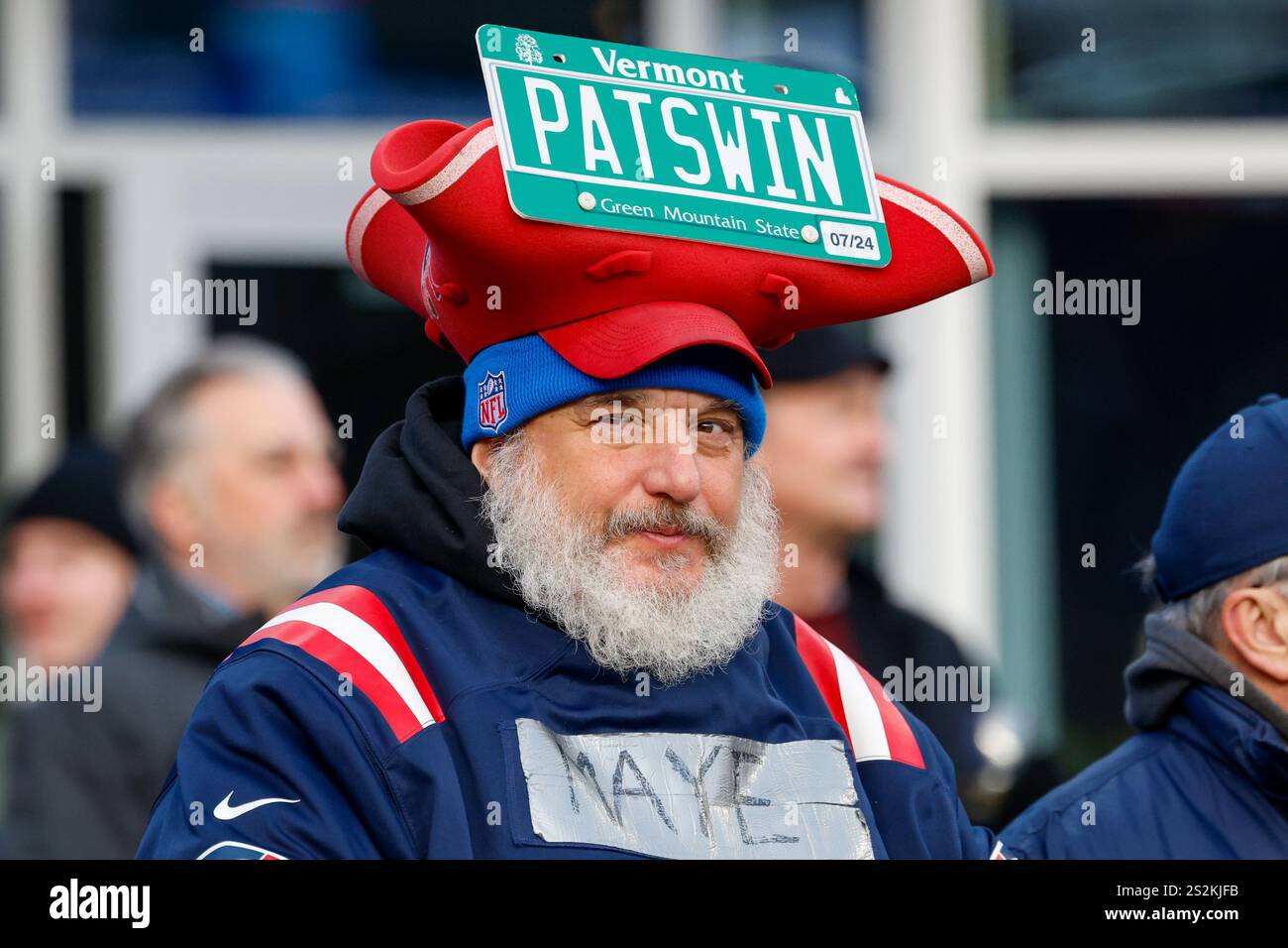 A New England Patriots fan wears a Vermont "Pats Win" license plate on ...