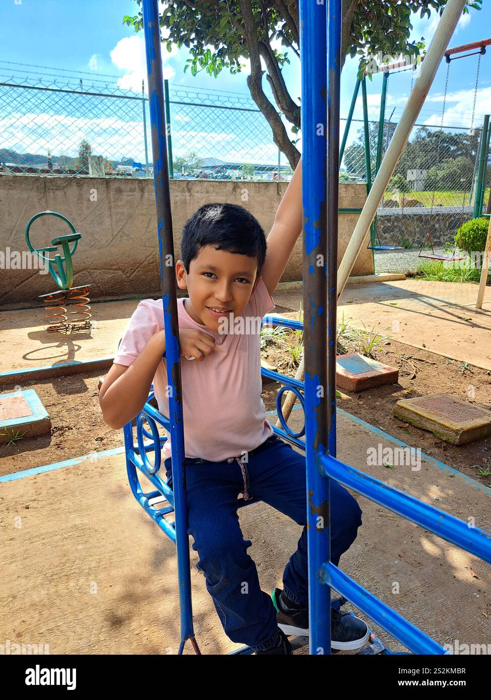 9-year-old dark-skinned Latino male child practices balance exercises ...