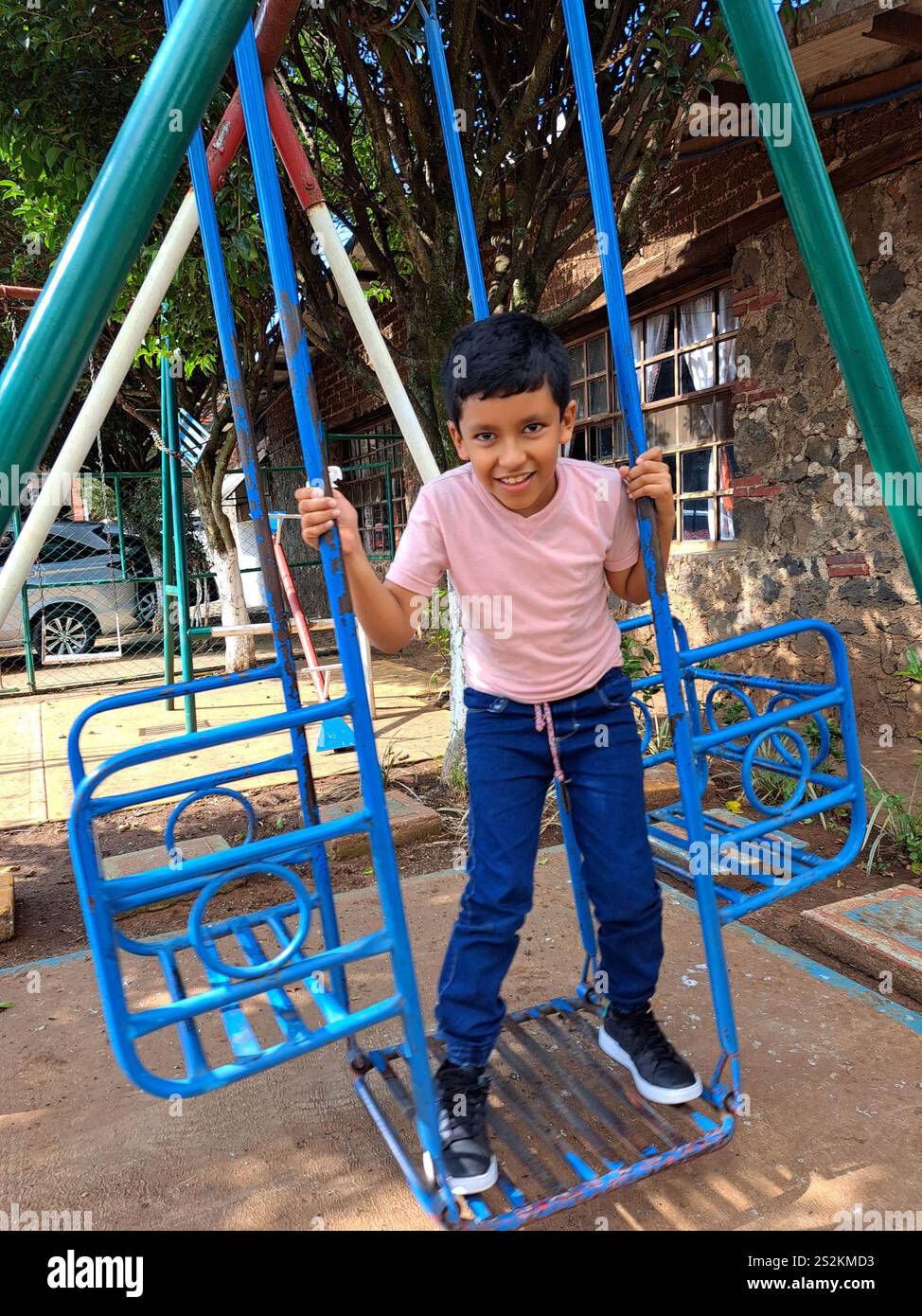 9-year-old dark-skinned Latino male child practices balance exercises ...