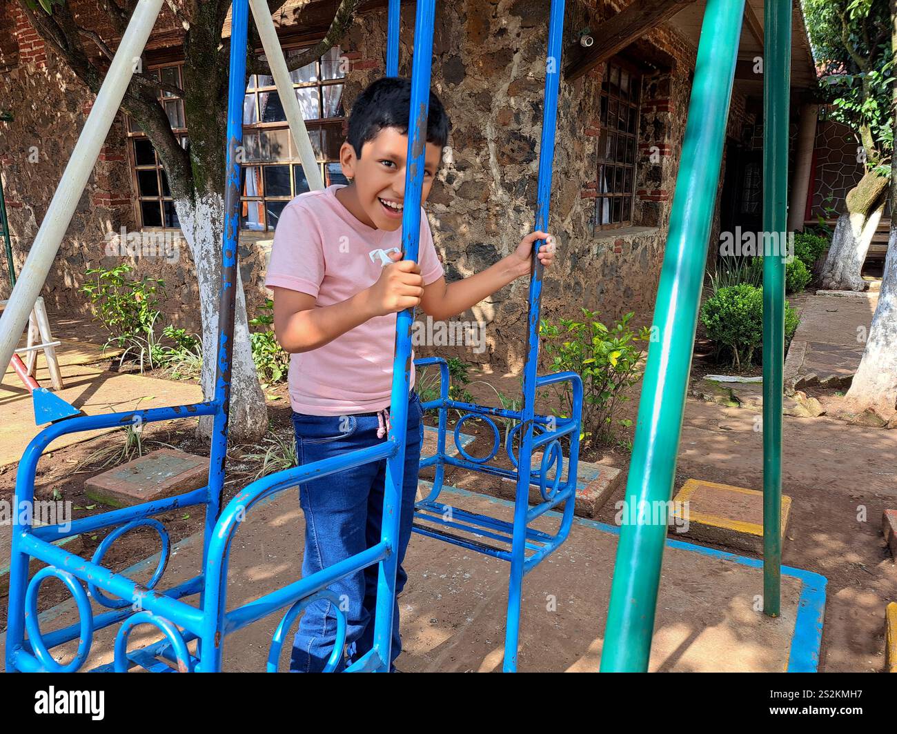 9-year-old dark-skinned Latino male child practices balance exercises ...