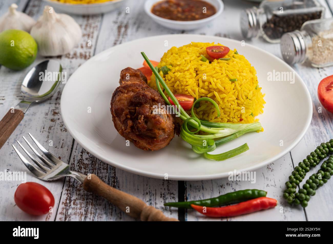Chicken Biryani in a plate with spices on a white wooden floor Stock ...