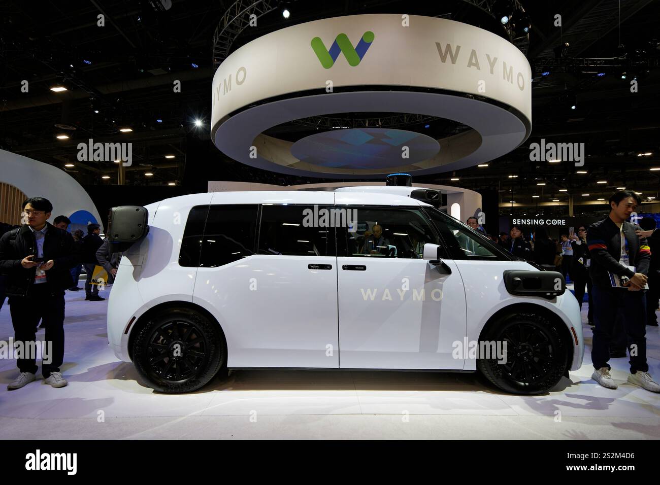 People look at a Zeekr RT vehicle with 6th Generation Waymo Driver on ...