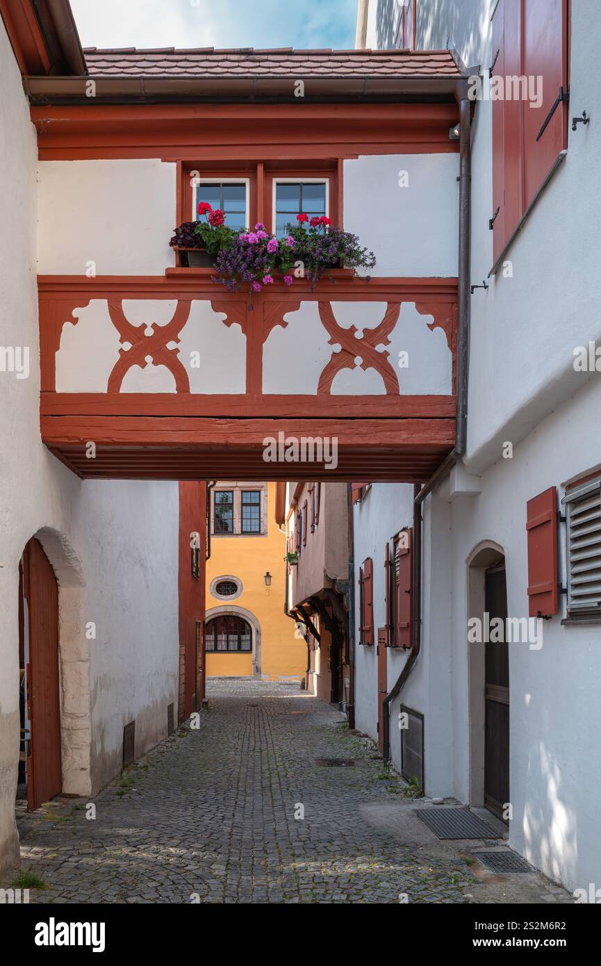 A charming narrow alley with traditional European medieval architecture ...
