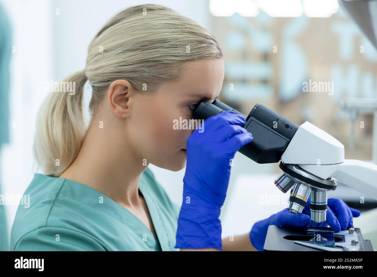 Medical woman wearing gloves working in sterile laboratory using ...