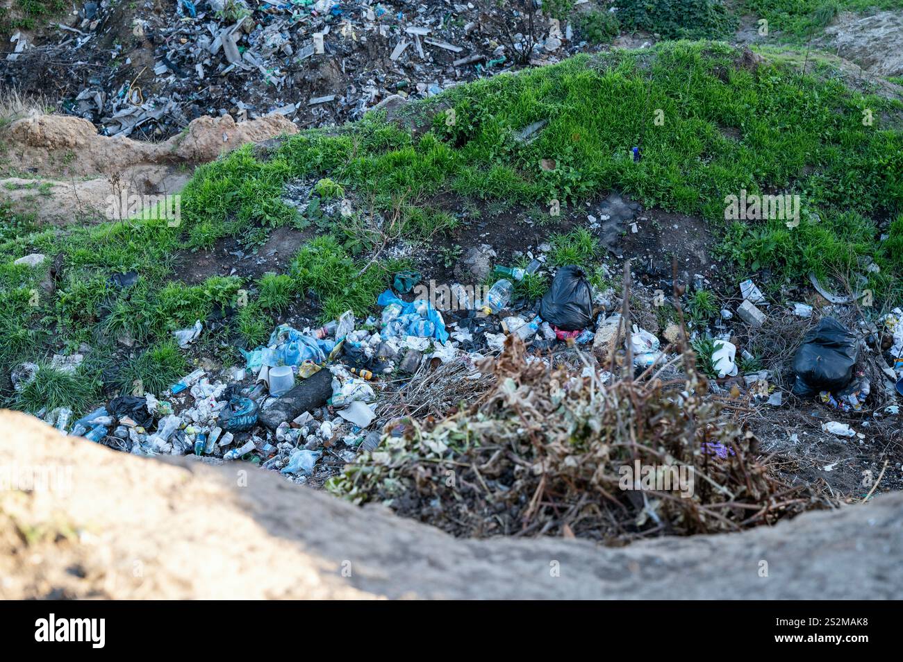 Ecological disaster. Garbage among the hills Stock Photo - Alamy