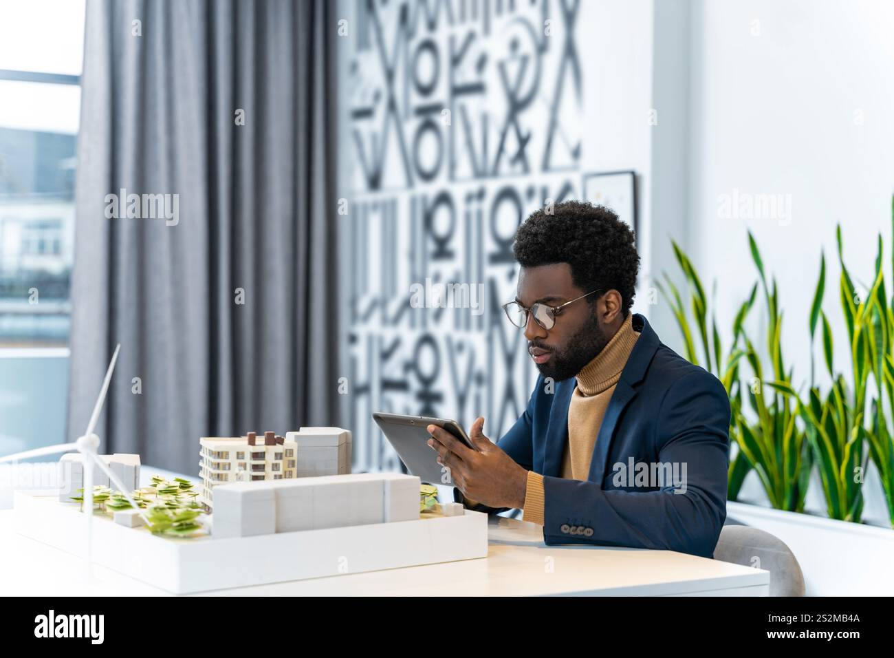 African american architect looking focused while scrutinizing the new ...