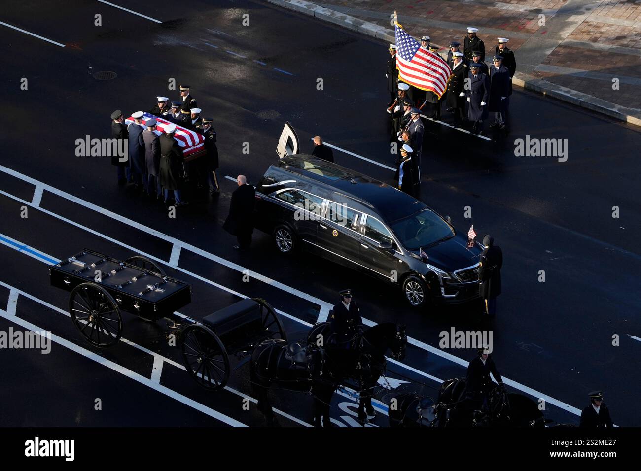 The flag-draped casket of former President Jimmy Carter is transferred ...
