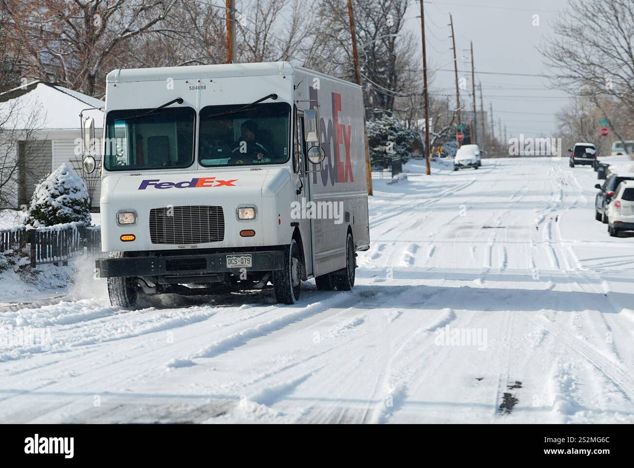 A FedEx delivery van moves along Colorado Avenue as a winter storm ...