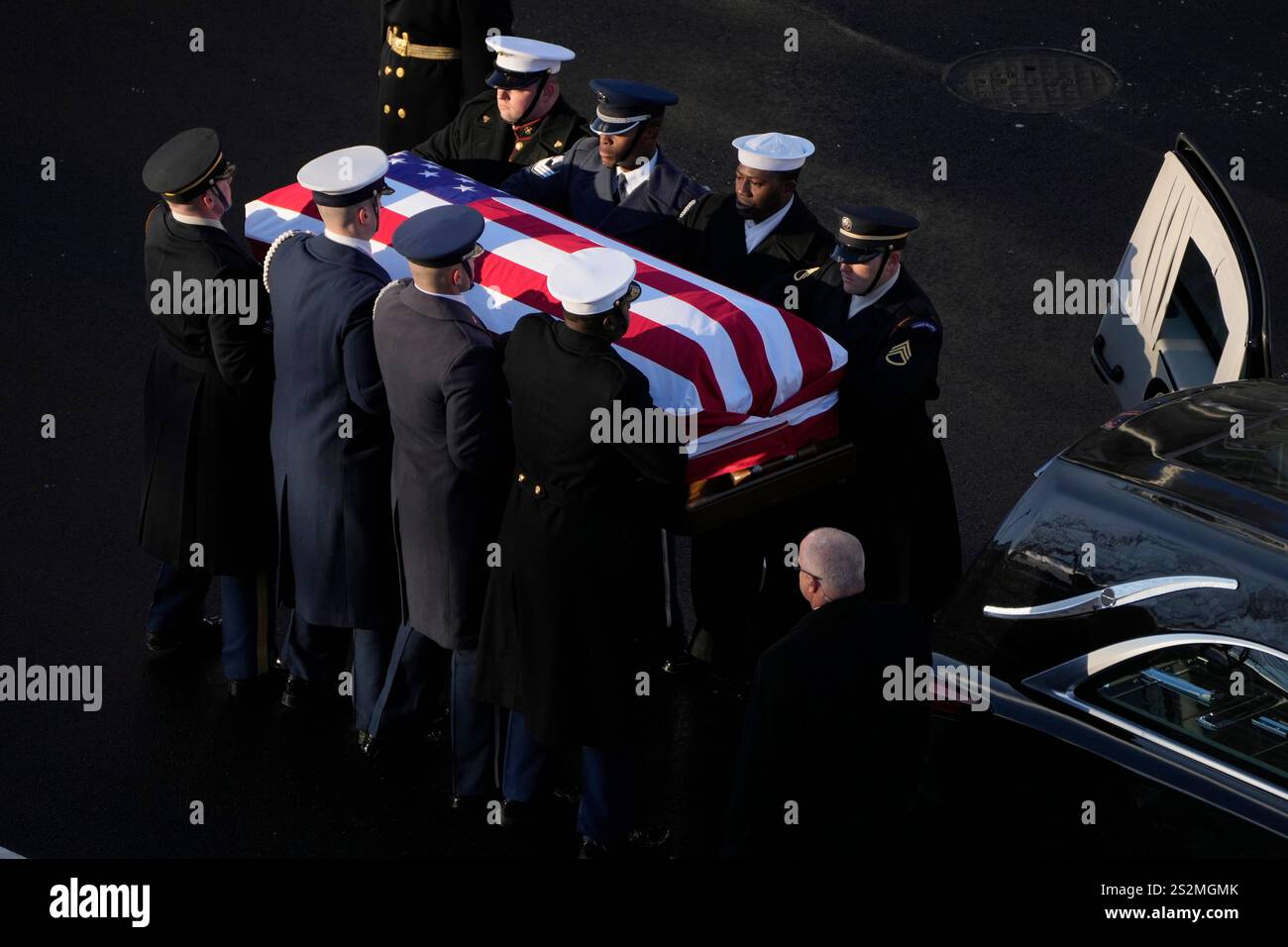 The flag-draped casket of former President Jimmy Carter is transferred ...