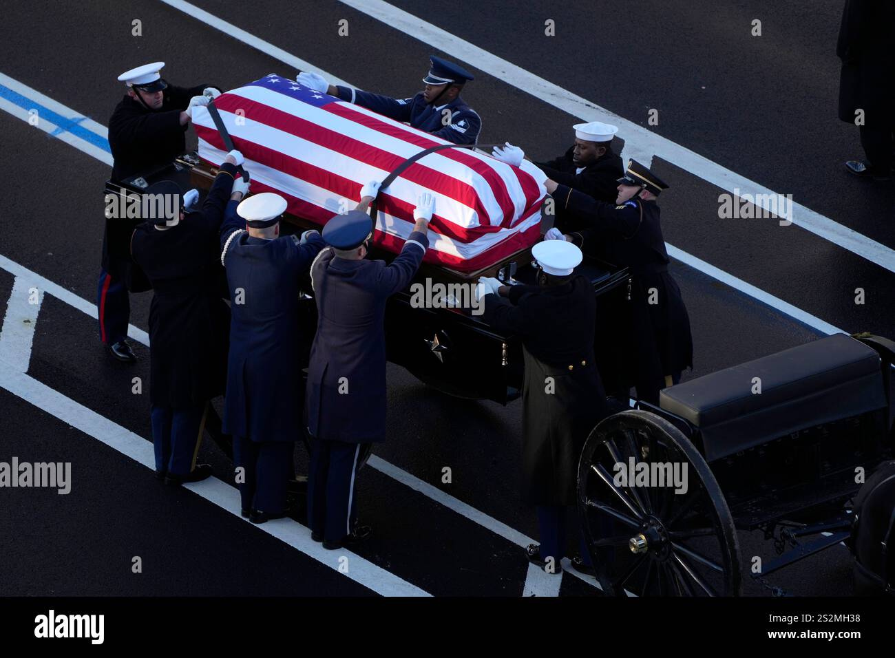 The flag-draped casket of former President Jimmy Carter is transferred ...