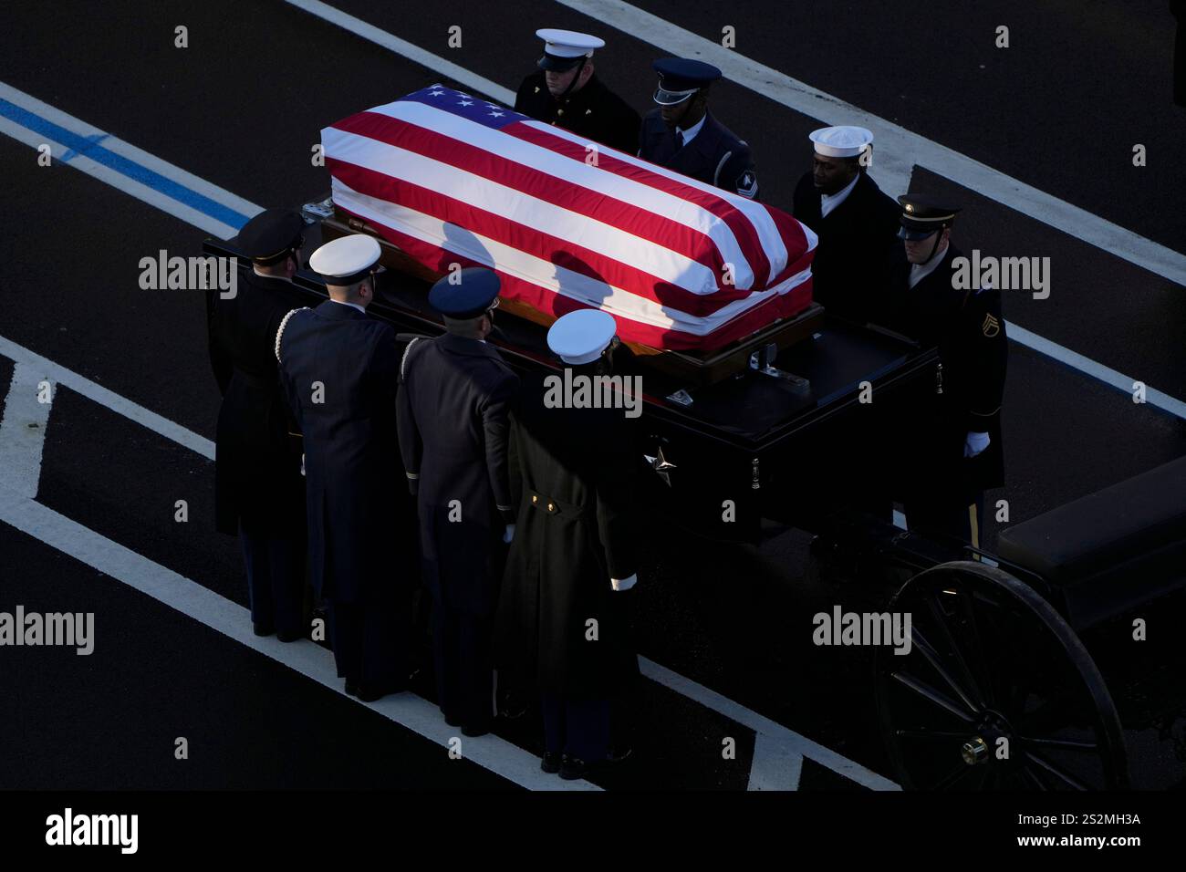 The flag-draped casket of former President Jimmy Carter is transferred ...