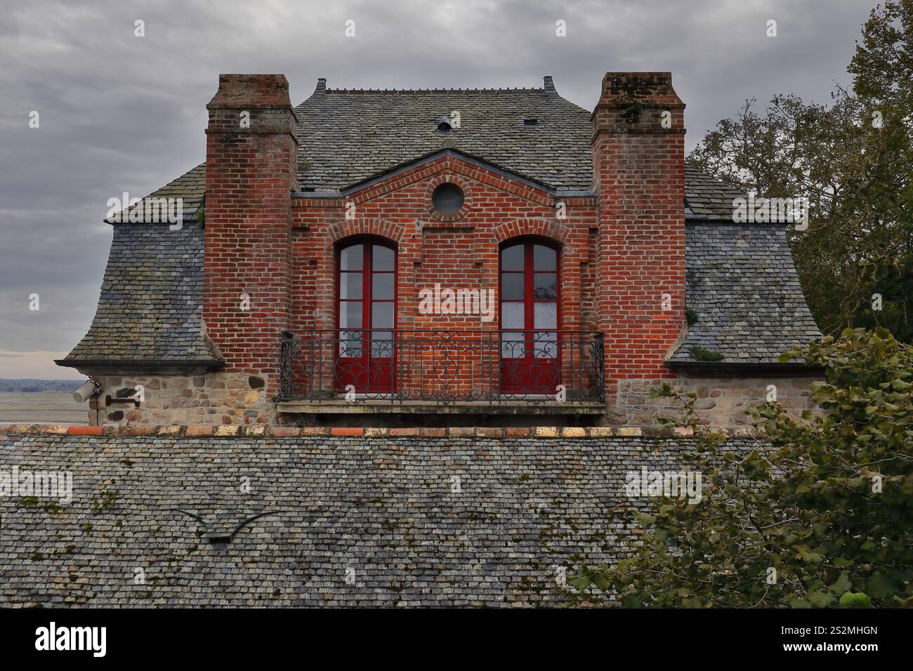 178 Mont-Saint-Michel: Pitched mansard roof of dark slate on the red brick northwest facade of ...