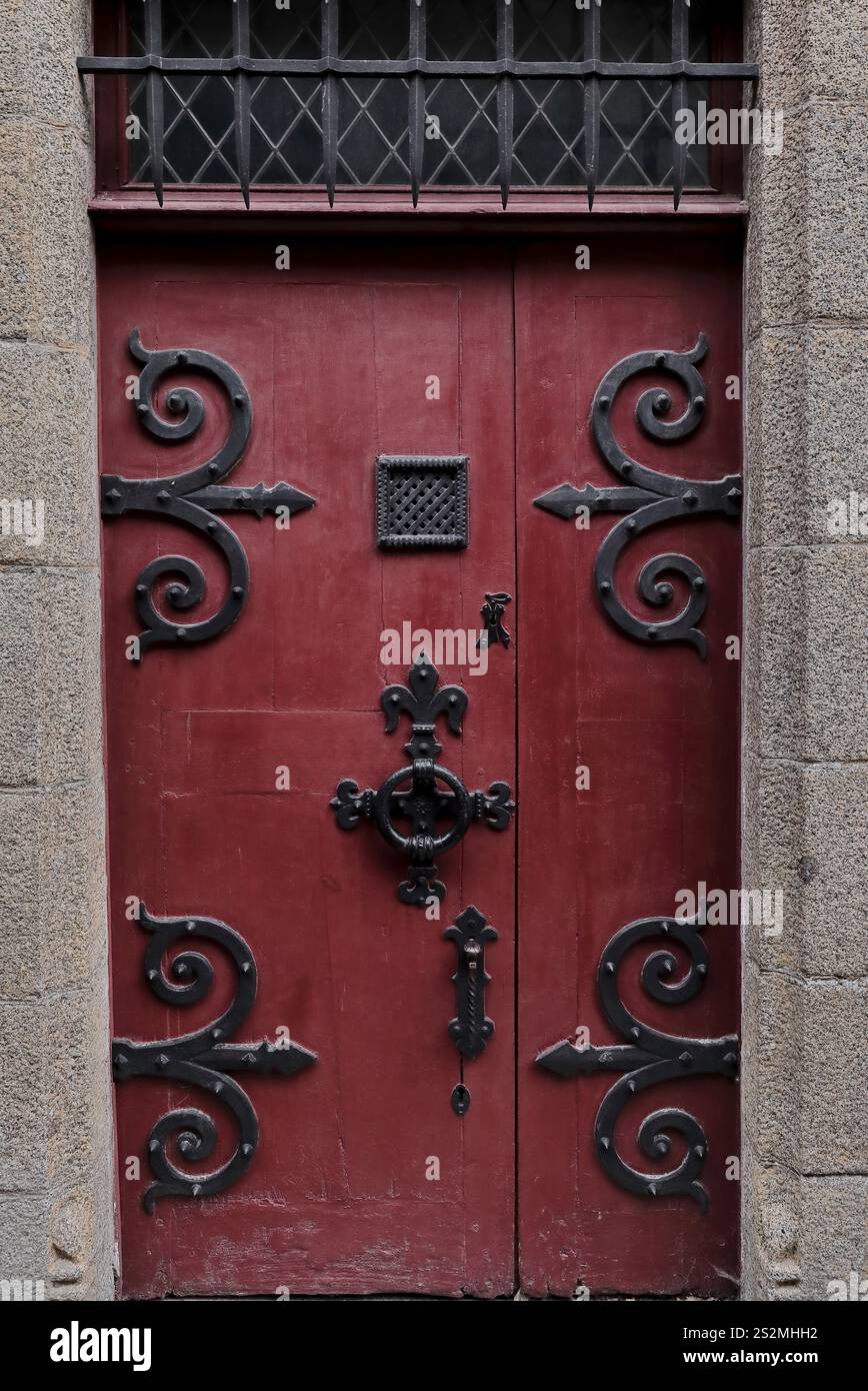 179 Mont-Saint-Michel: Old red painted, studded wood door of a XIV ...