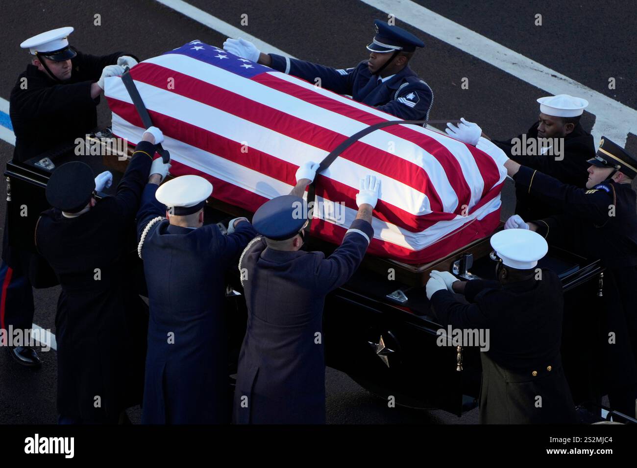 The flag-draped casket of former President Jimmy Carter is transferred ...
