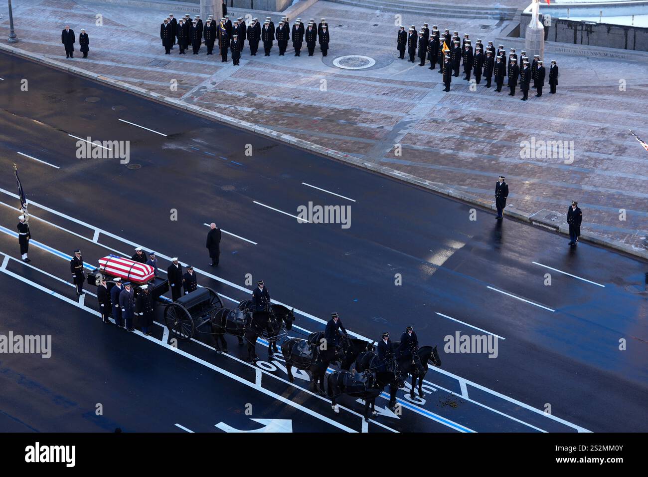 The flag-draped casket of former President Jimmy Carter travels in a ...