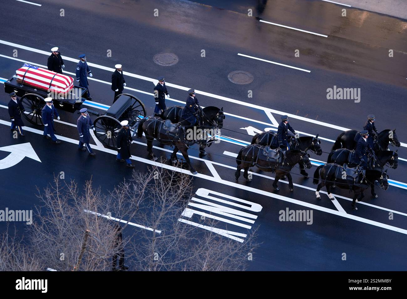 The flag-draped casket of former President Jimmy Carter travels in a ...