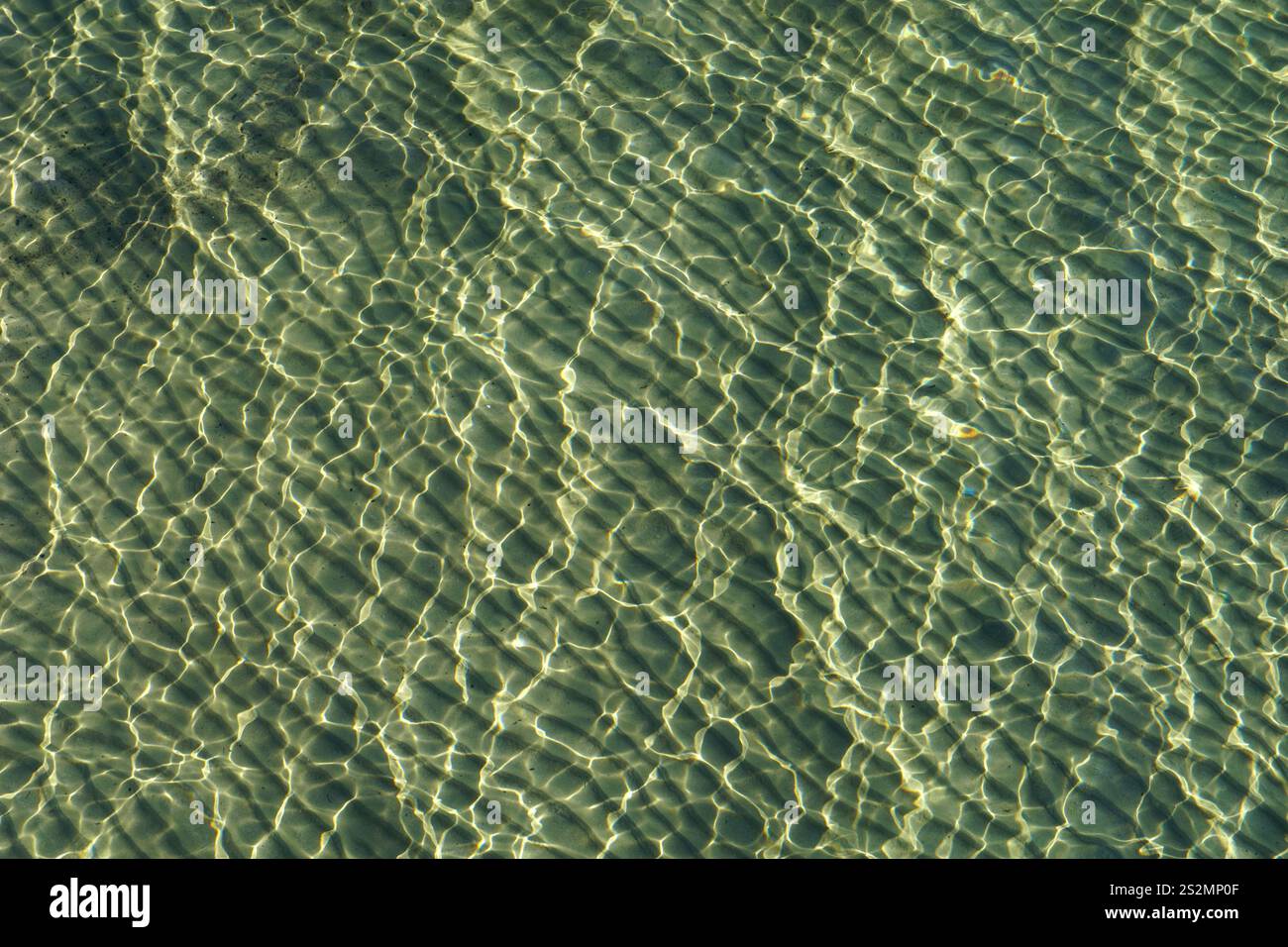 Marble turquoise surface of the sea and waves with shadows from the sun ...