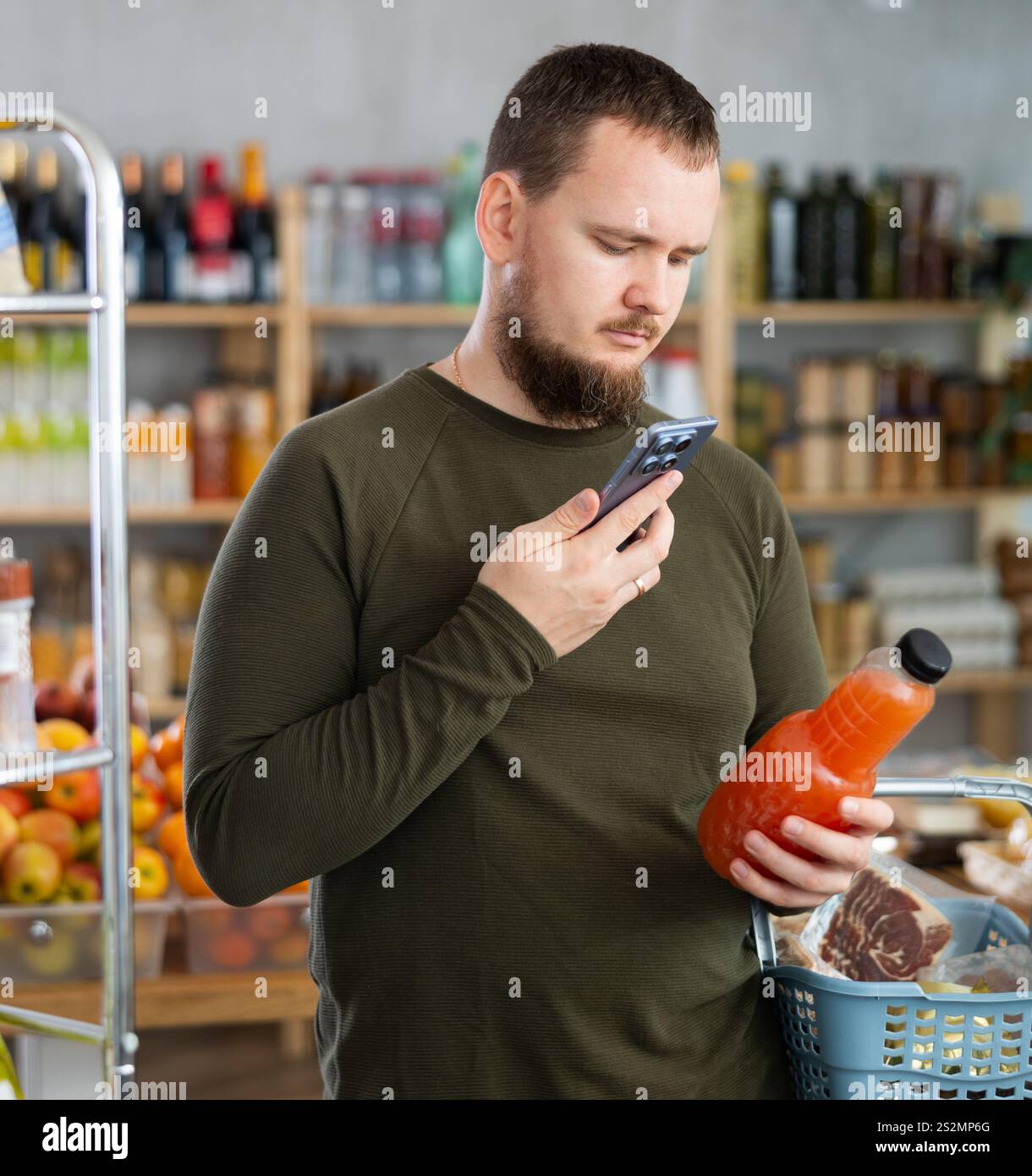 Man purchaser scanning QR code or barcode of bottle grapefruit in ...