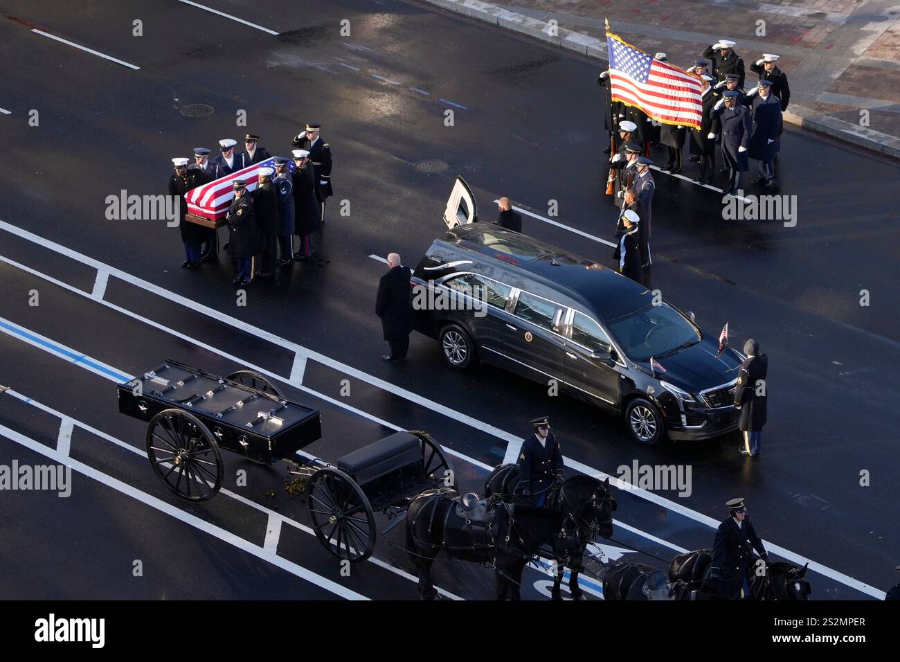 The flag-draped casket of former President Jimmy Carter is transferred ...