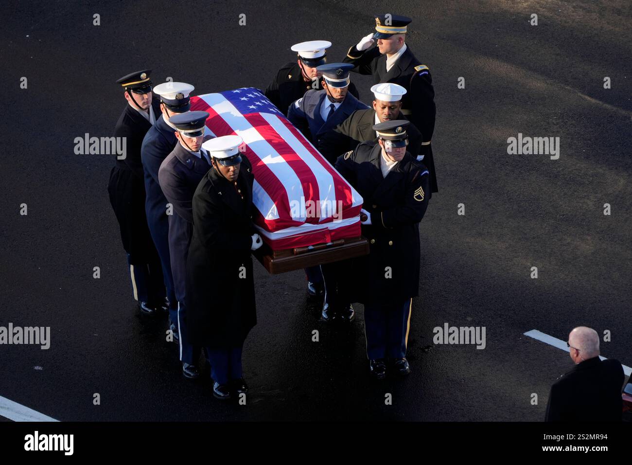 The flag-draped casket of former President Jimmy Carter is transferred ...