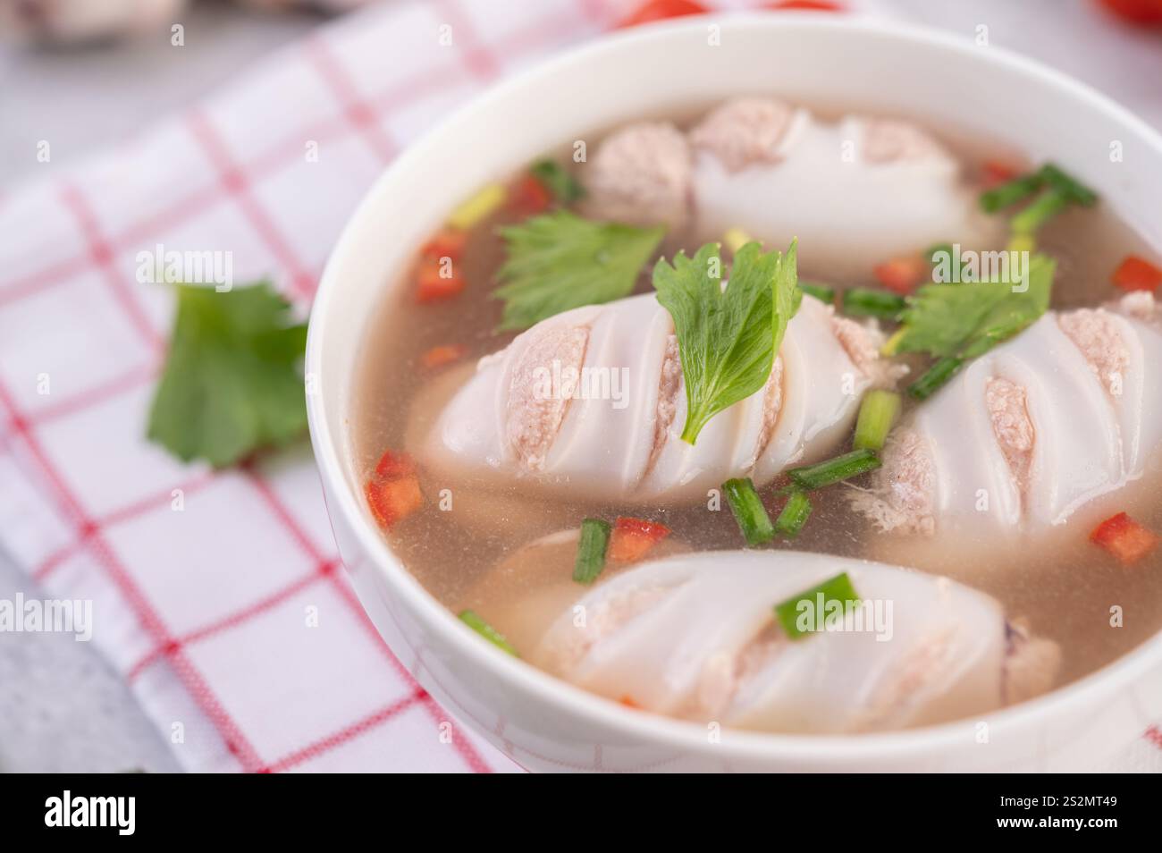 Squid soup stuffed with pork, sprinkled with coriander and chopped ...