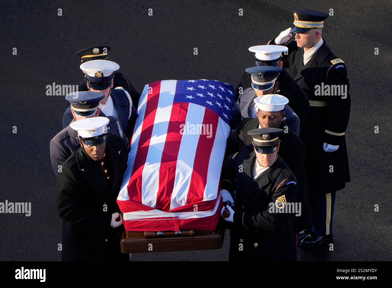 The flag-draped casket of former President Jimmy Carter is transferred ...