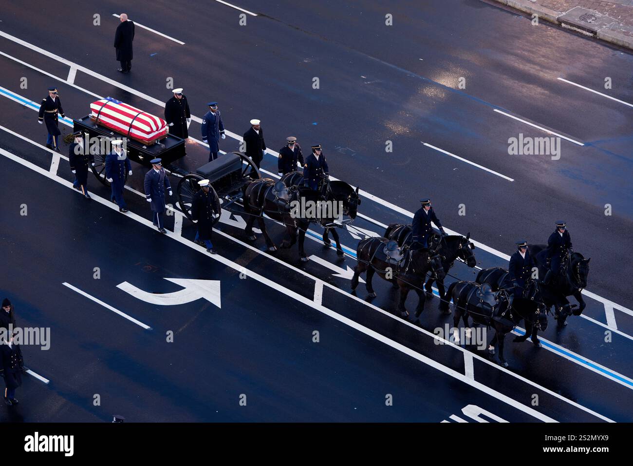 The flag-draped casket of former President Jimmy Carter travels in a ...