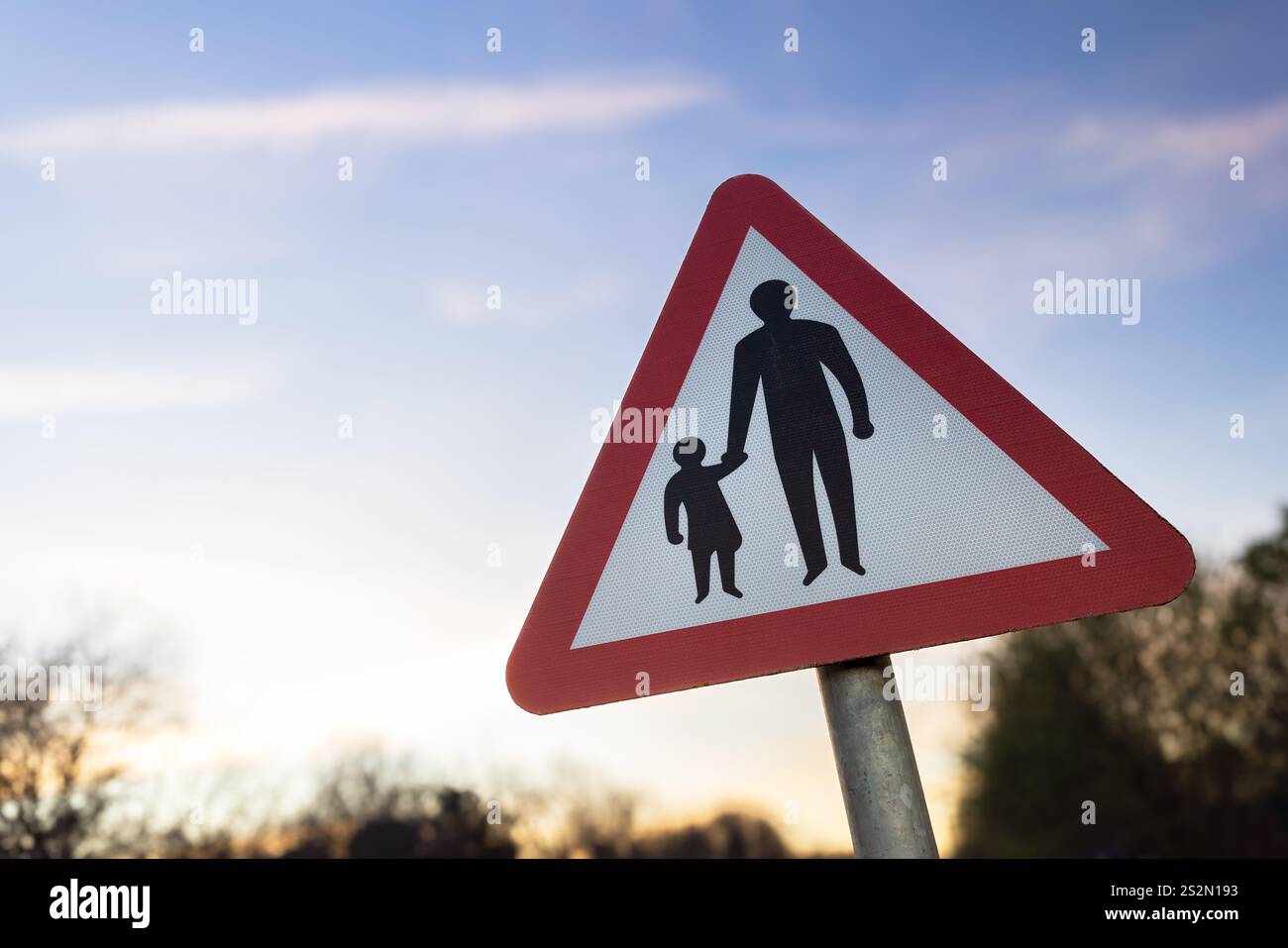 Parents and Children Crossing Warning Road Sign Outside a School in ...