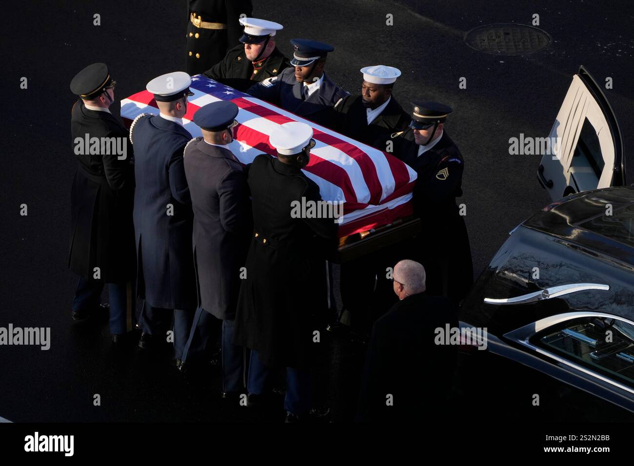 The flag-draped casket of former President Jimmy Carter is transferred ...